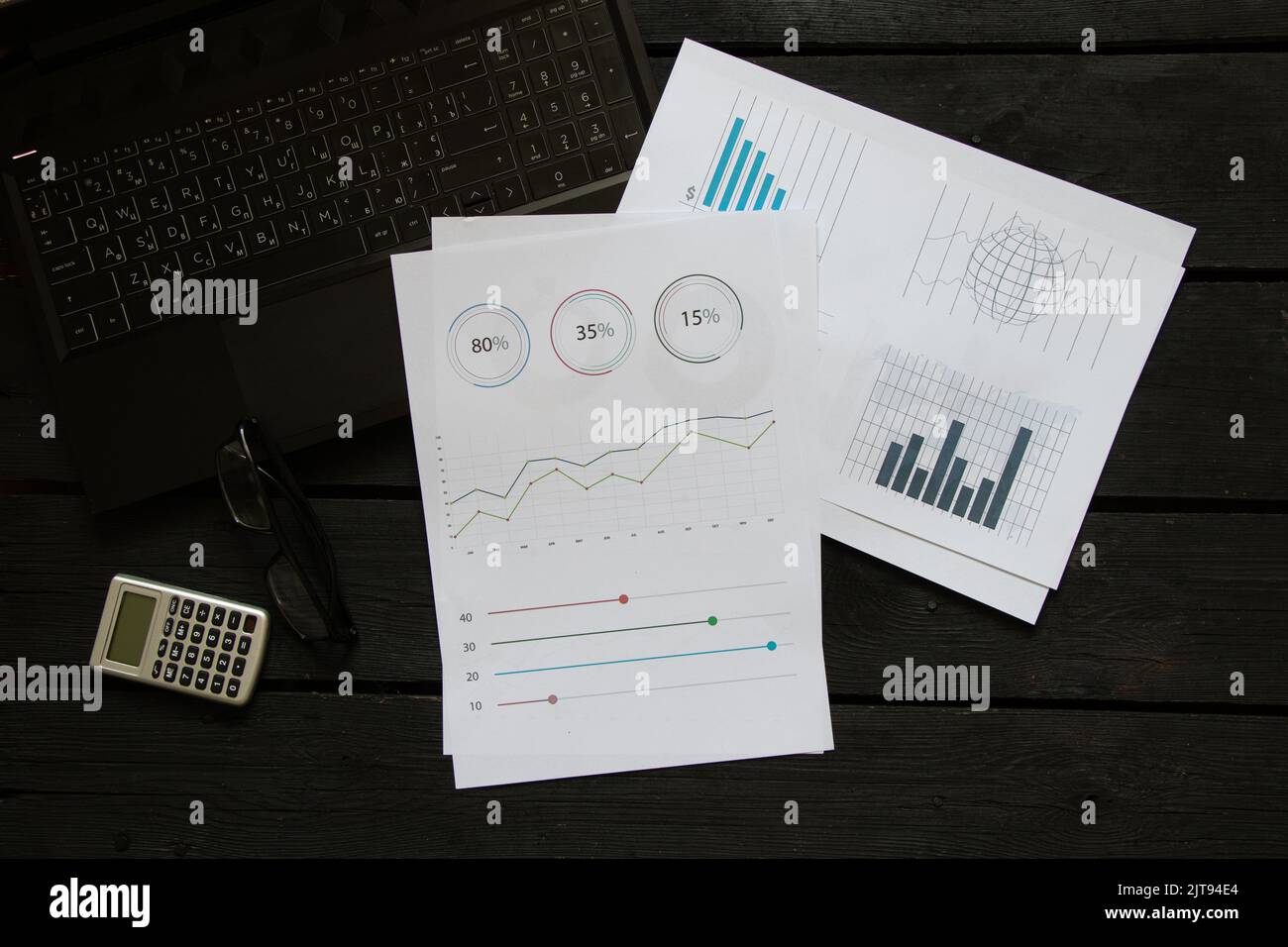reports and histograms on paper on the table, analytics and statistics ...