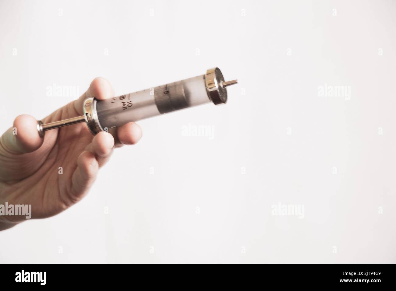 replaceable old glass syringe in the doctor's hands, injections and ...