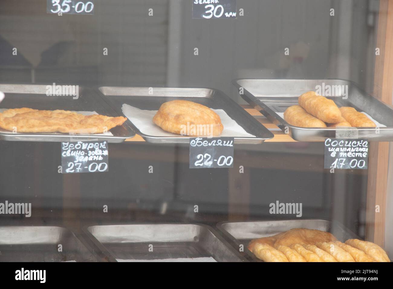 pies with meat on the showcase of a small private bakery take-away in ...