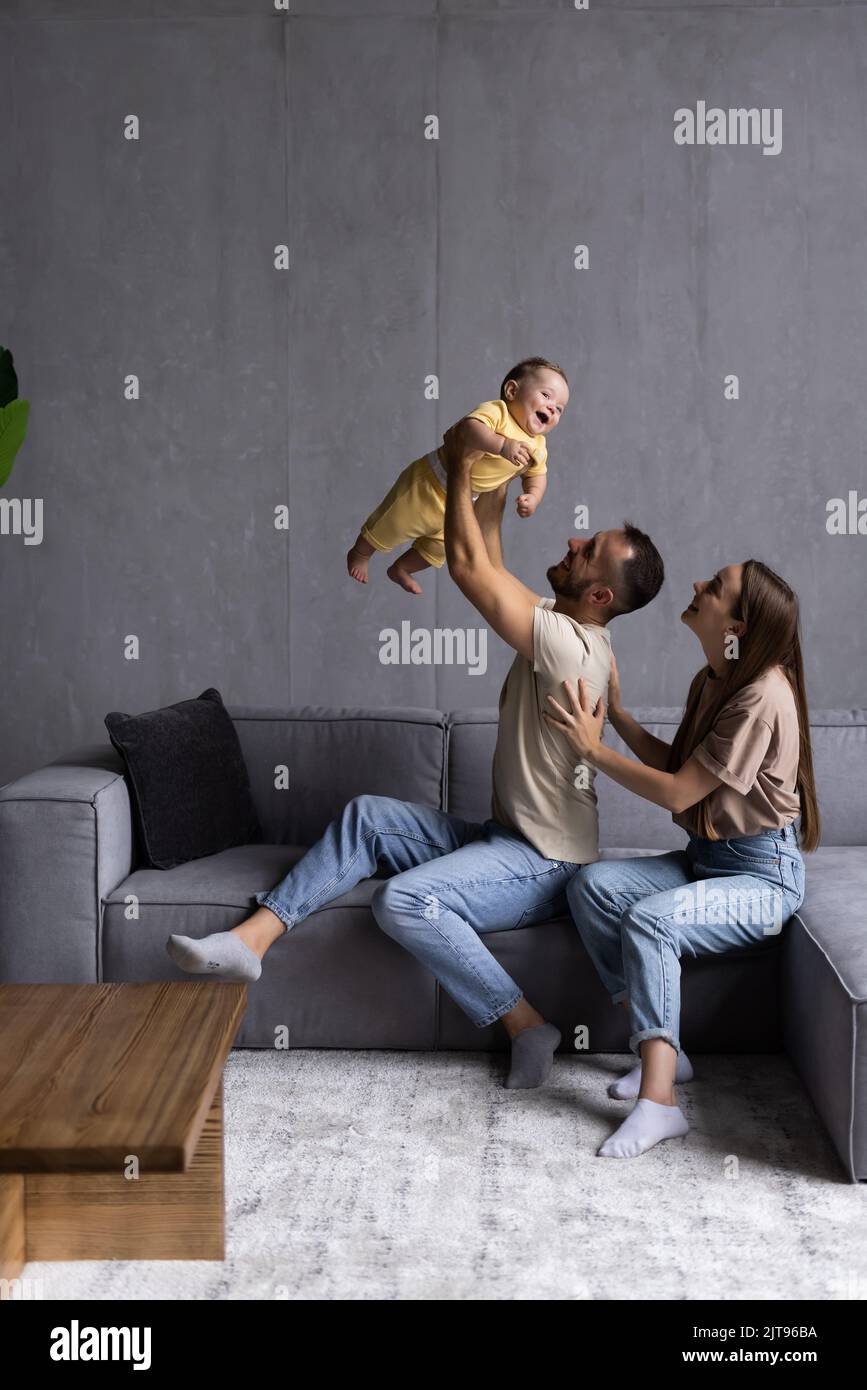 happy family mother father and kid having fun at home on the couch Stock Photo - Alamy
