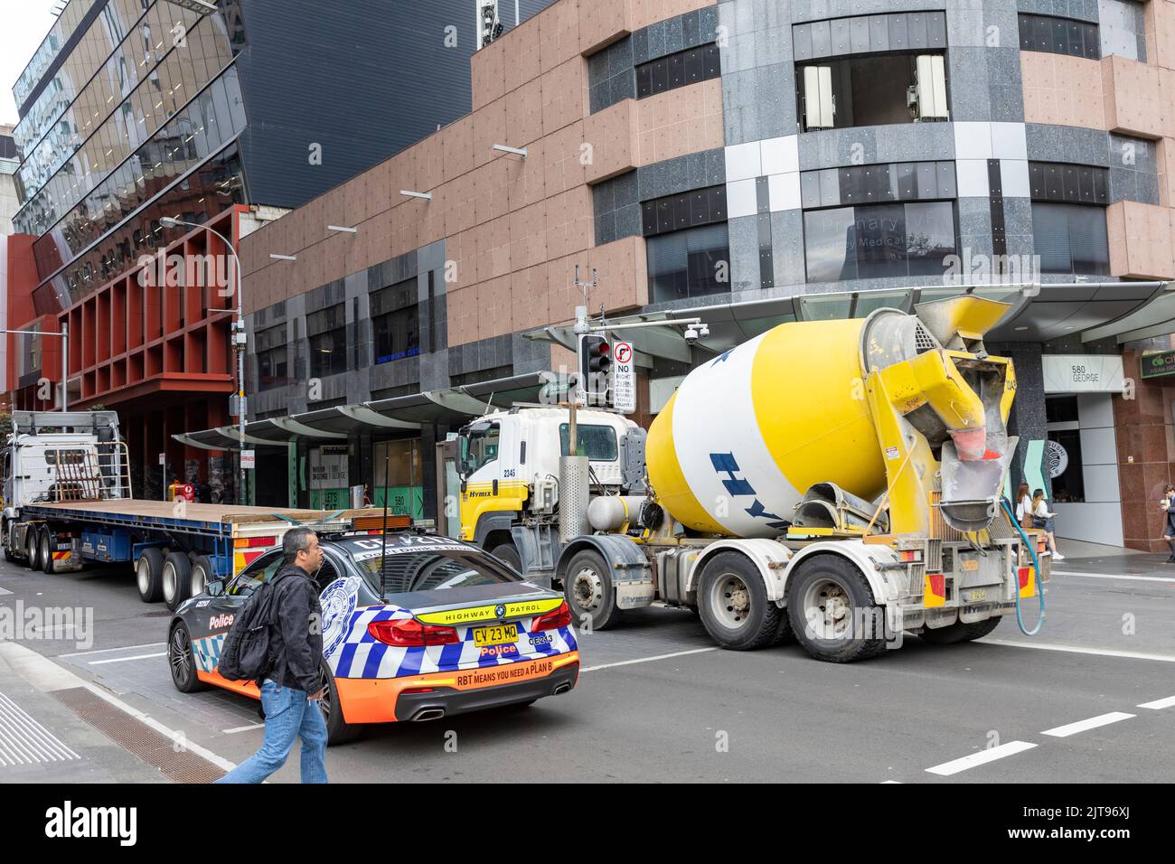 BMW police car and ready mix concrete truck in the traffic in Sydney ...