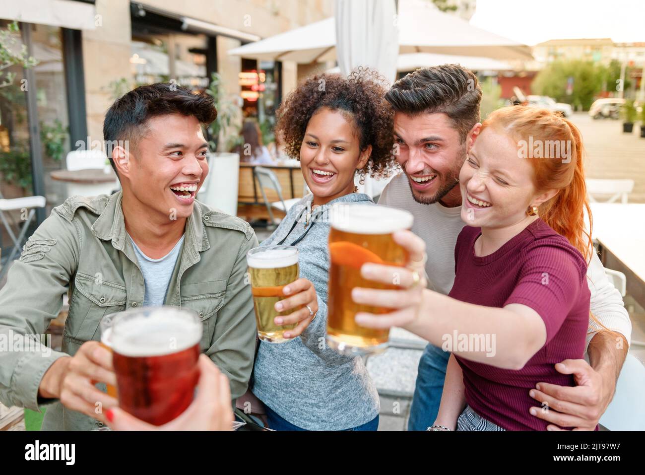 Diverse company friends clinking glasses hi-res stock photography and ...