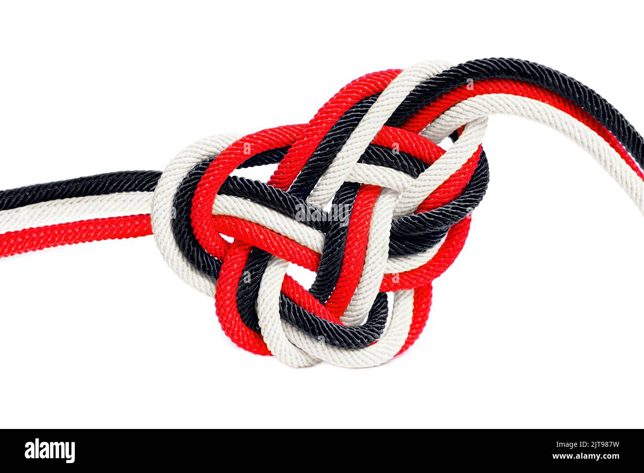 Heart-shaped celtic knot made from braided cotton cords dyed red, white ...