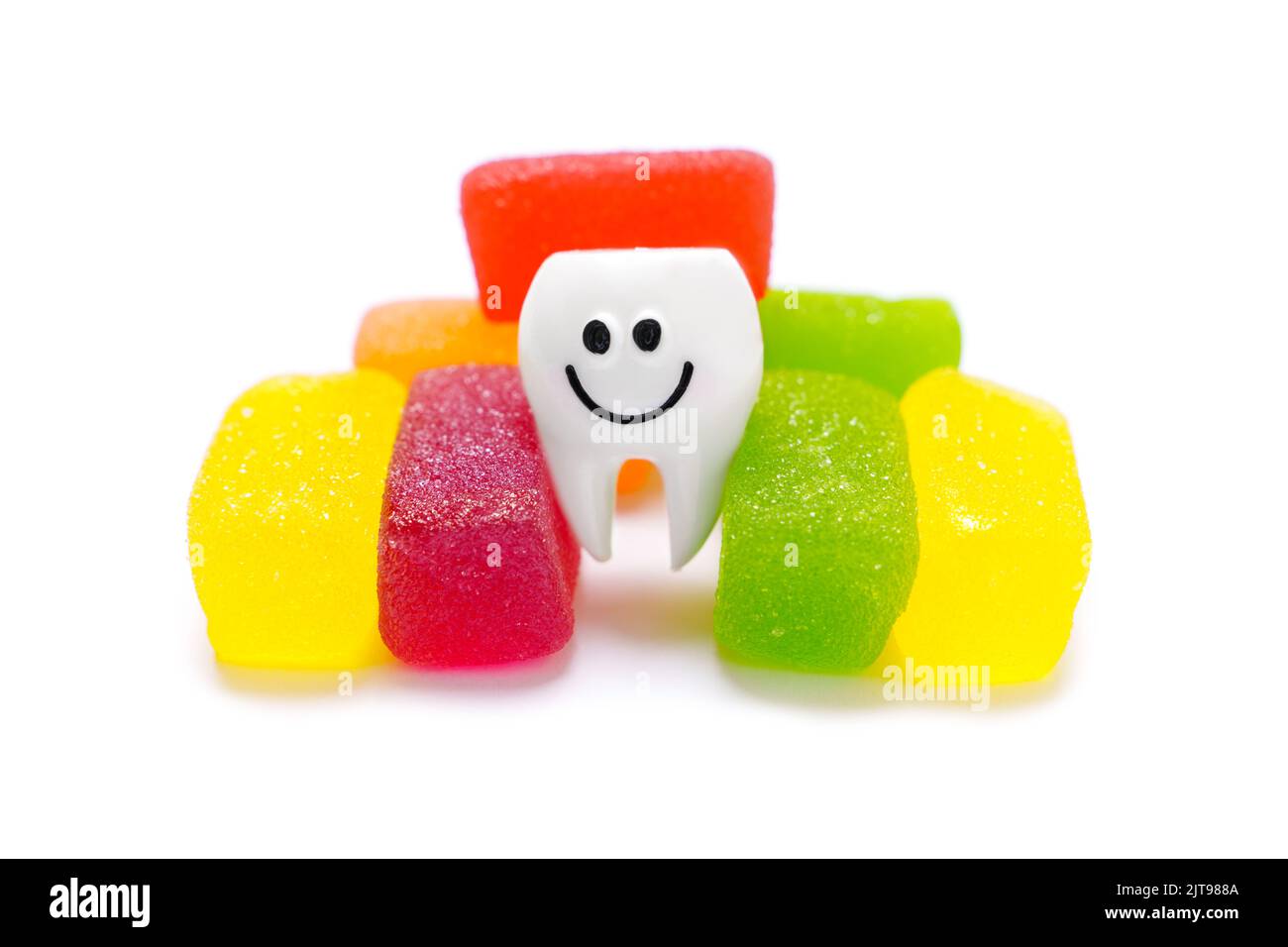 Cute and funny tooth character with a bunch of colorful jelly candies ...