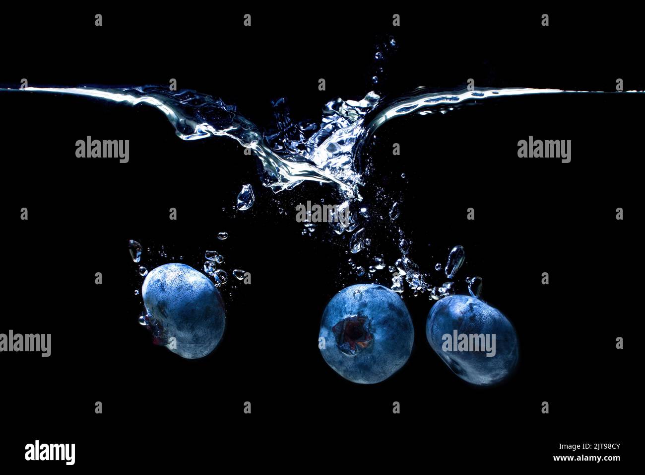 Blueberries sinking underwater with air bubbles and splashes isolated ...