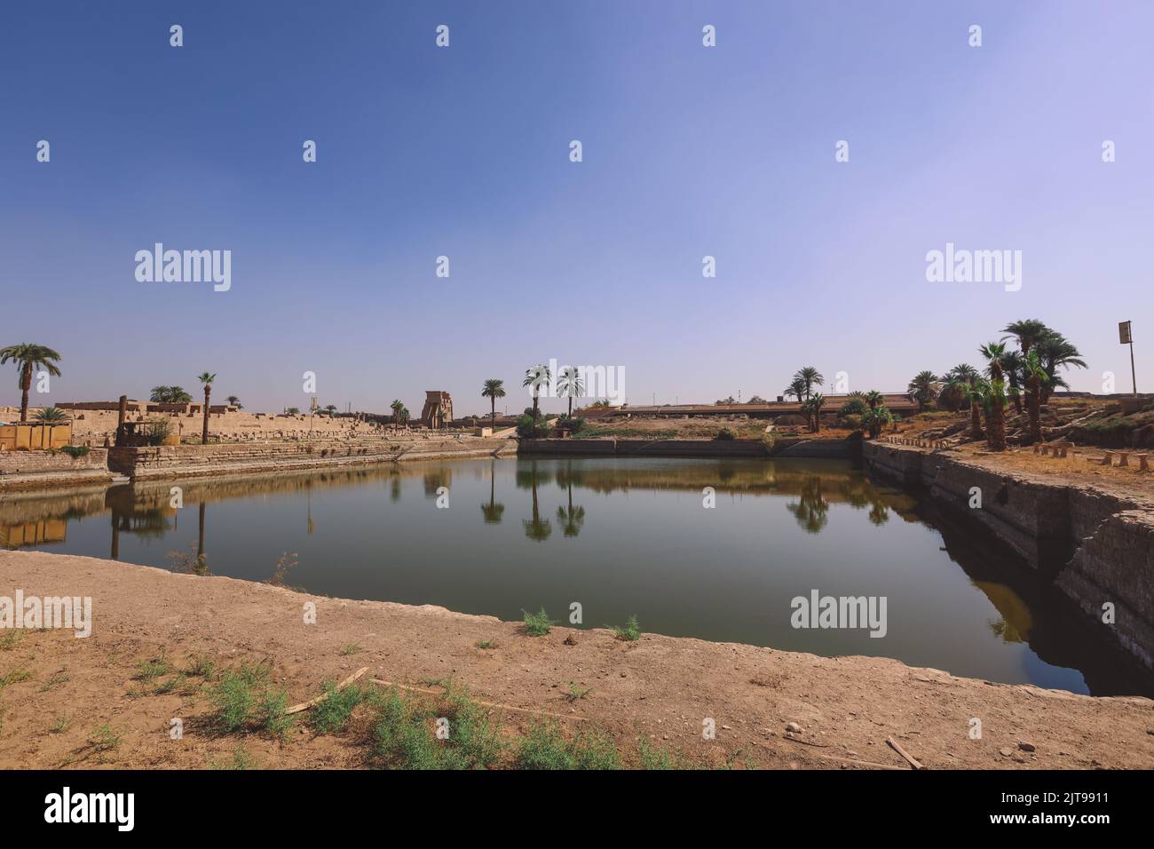 Ancient Lake in the Karnak Temple Complex with the Palm Trees around ...