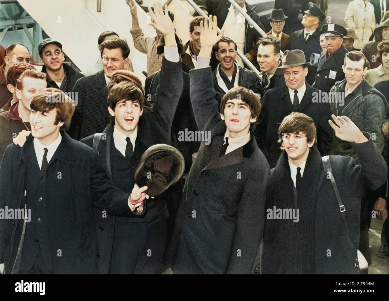 The Beatles wave to fans after arriving at Kennedy Airport. United ...