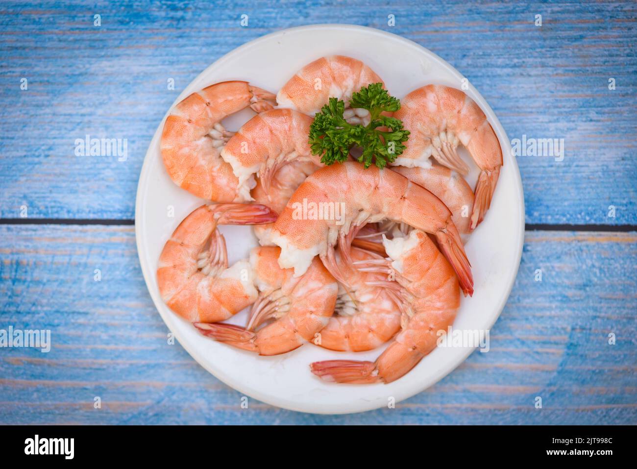 Fresh shrimps served on white plate, boiled peeled shrimp prawns cooked ...