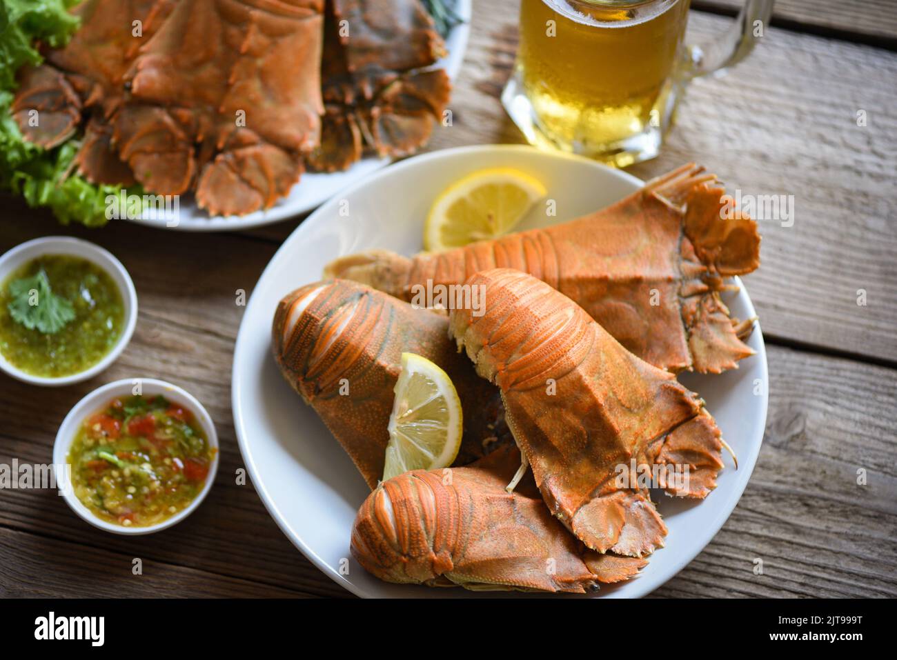 Fresh slipper lobster flathead boiled cooking with parsley rosemary in ...