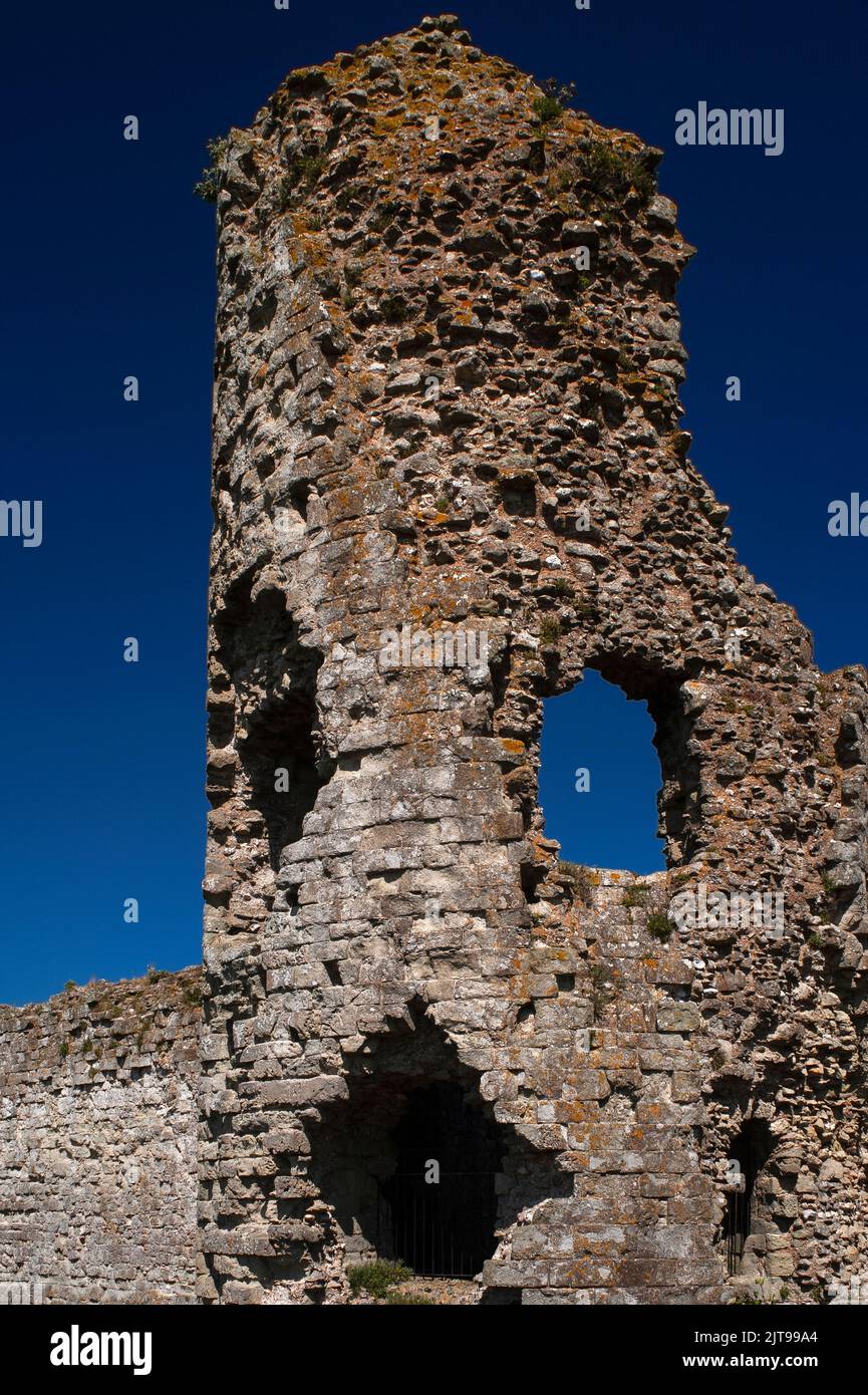 Holes in the walls of a ruined gatehouse tower create the likeness of a ...