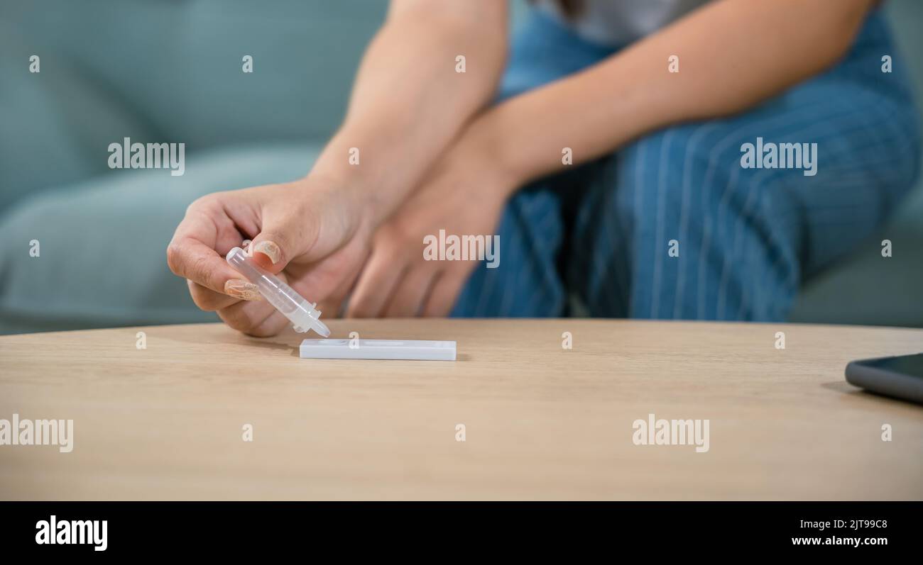 Close up woman hands using rapid antigen test kit for selftest, female ...
