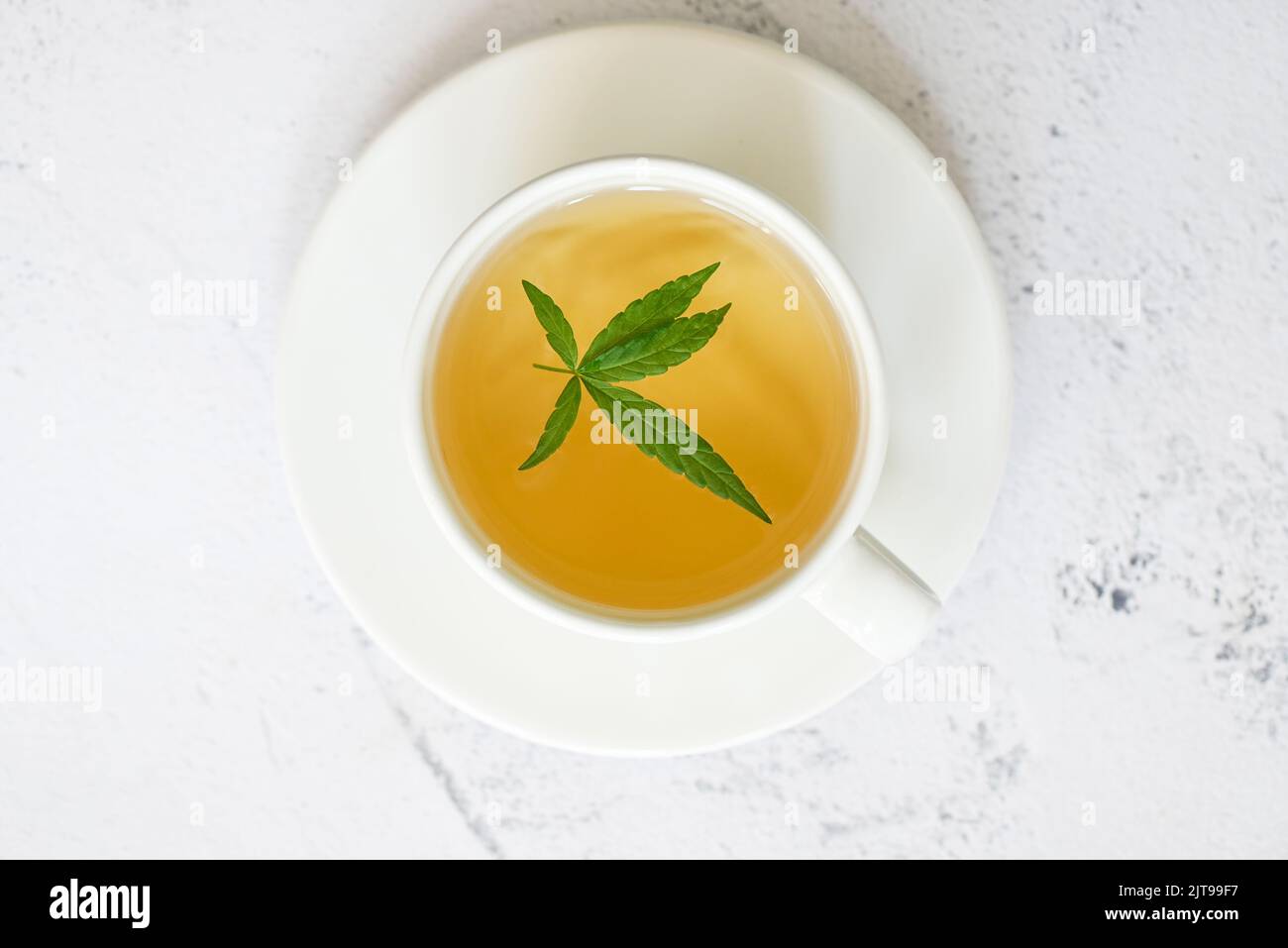 Cannabis tea herbal on tea cup with cannabis leaf marijuana leaves herb ...