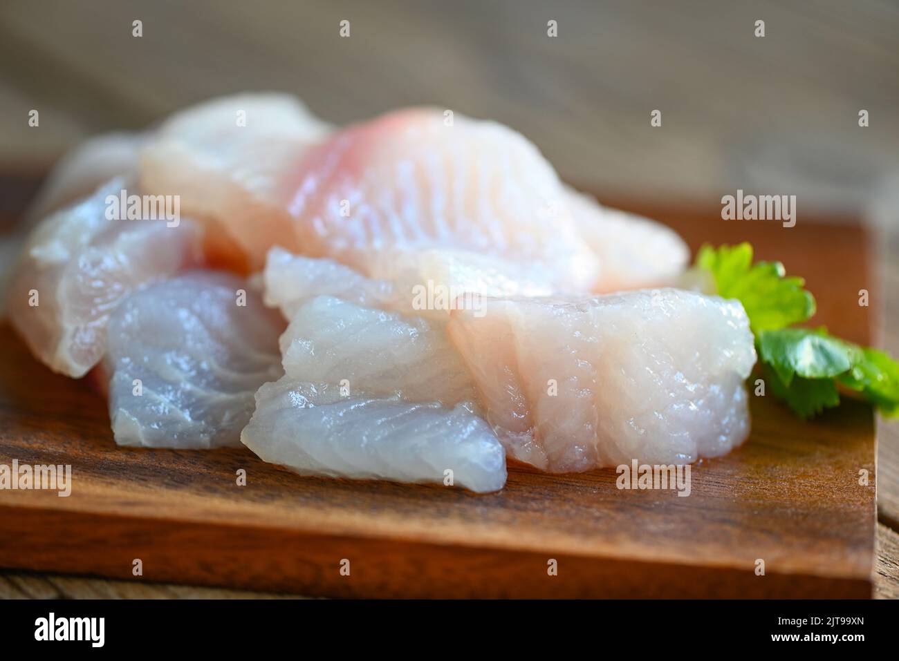 fish fillet on wooden board with ingredients celery for cooking, fresh ...
