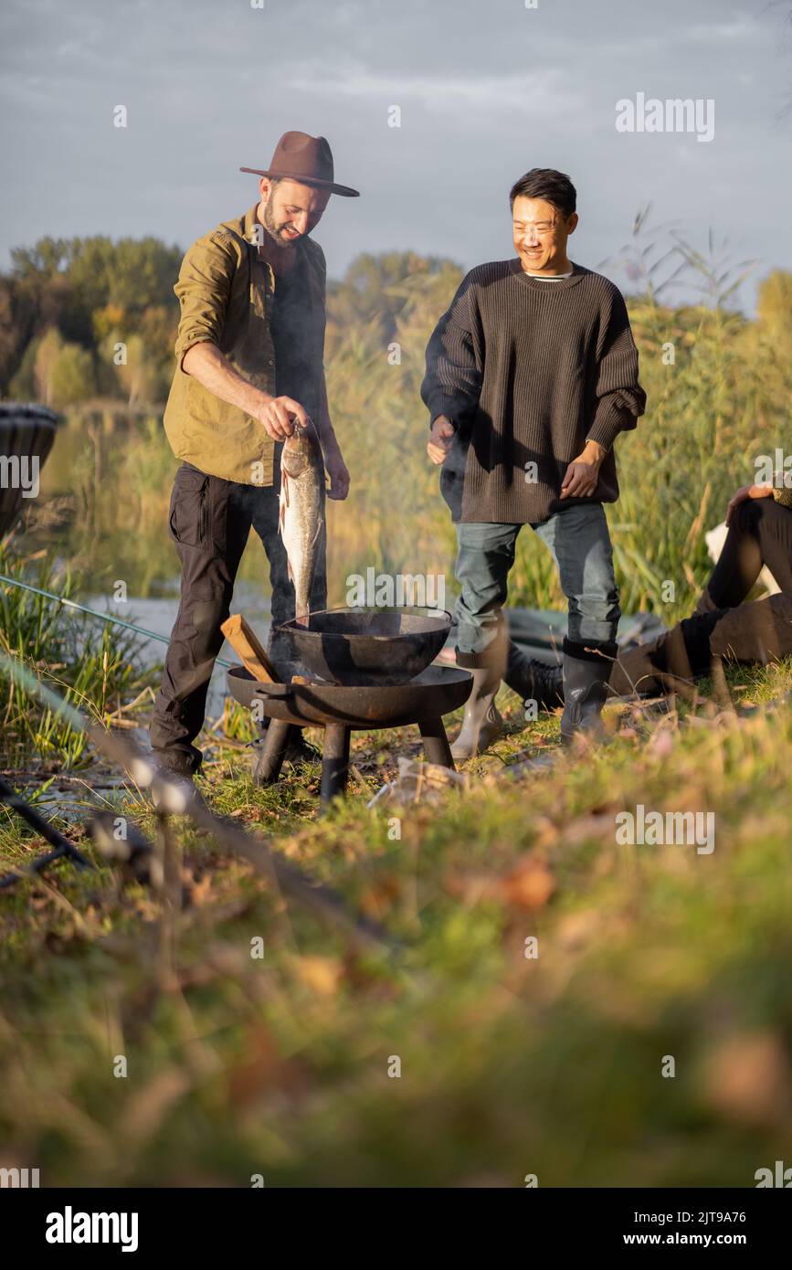 Asian man cooking fish hi-res stock photography and images - Alamy