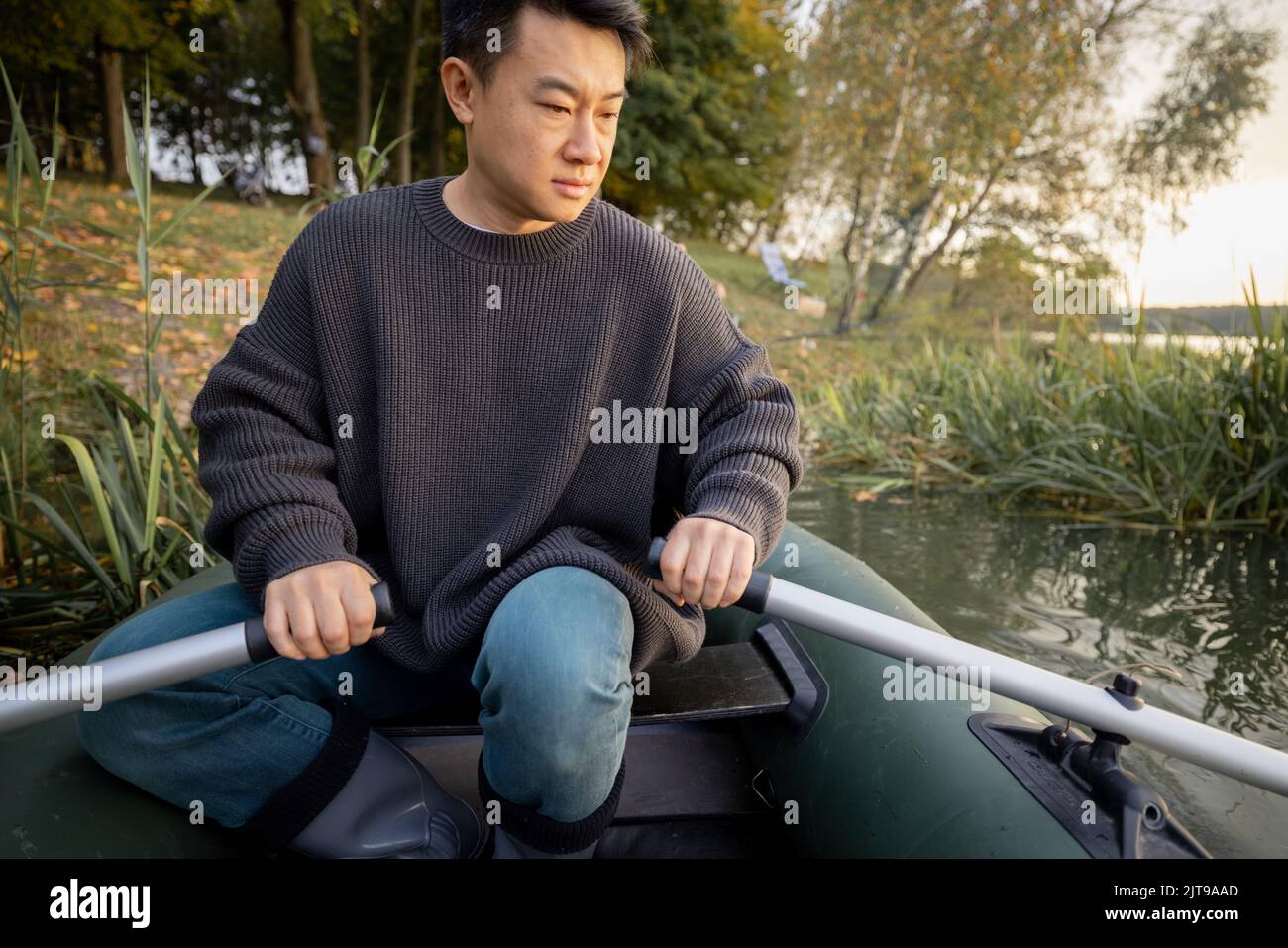 Man float on rubber boat in lake at autumn morning Stock Photo - Alamy