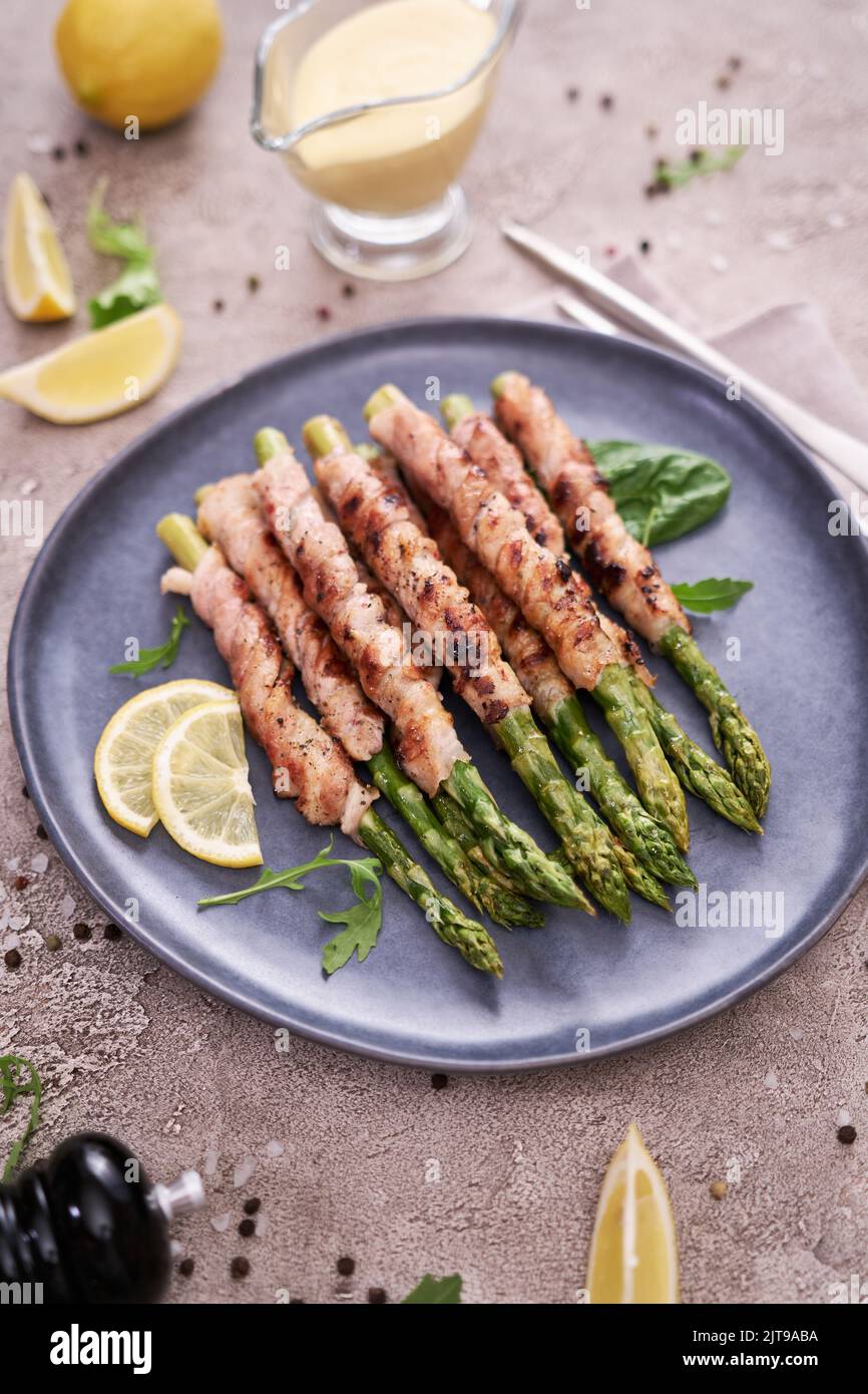 Healthy food - Asparagus wrapped with bacon and spices on a plate Stock ...