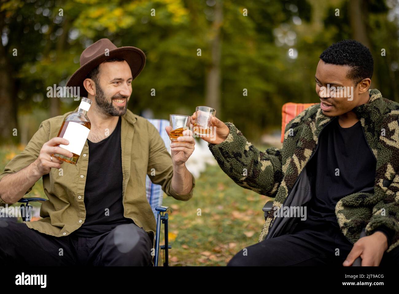 Two male friends fishing with alcoholic drinks Stock Photo - Alamy