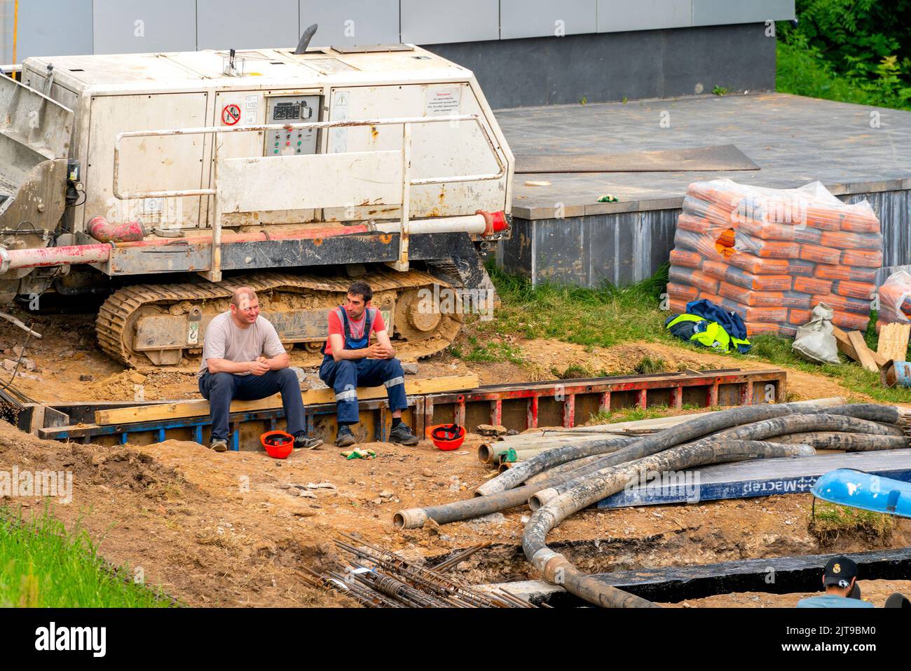 The two workers resting on the construction site Stock Photo - Alamy