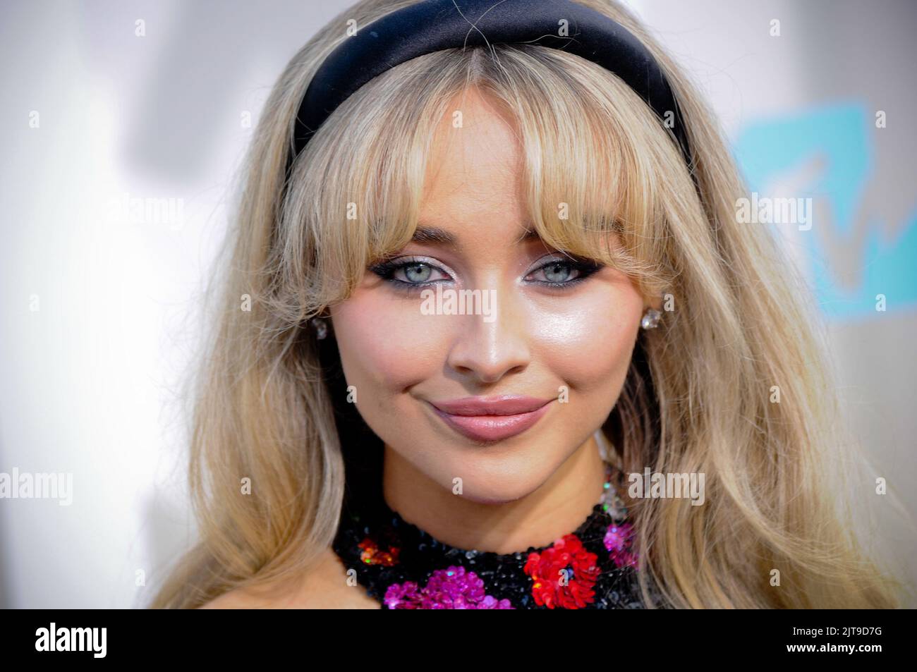 Sabrina Carpenter walking on the black carpet at the 2022 MTV Video ...