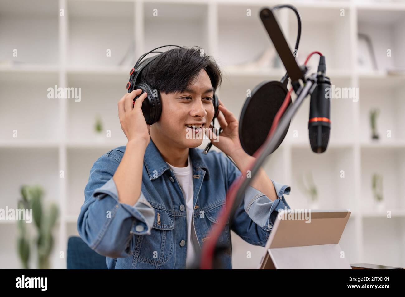 Asian male podcaster making audio podcast from her home studio Stock ...