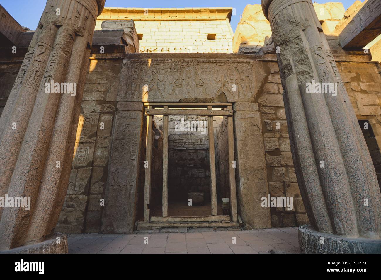 Sunset View to an Illuminated in Yellow Grand colonnade of large ...