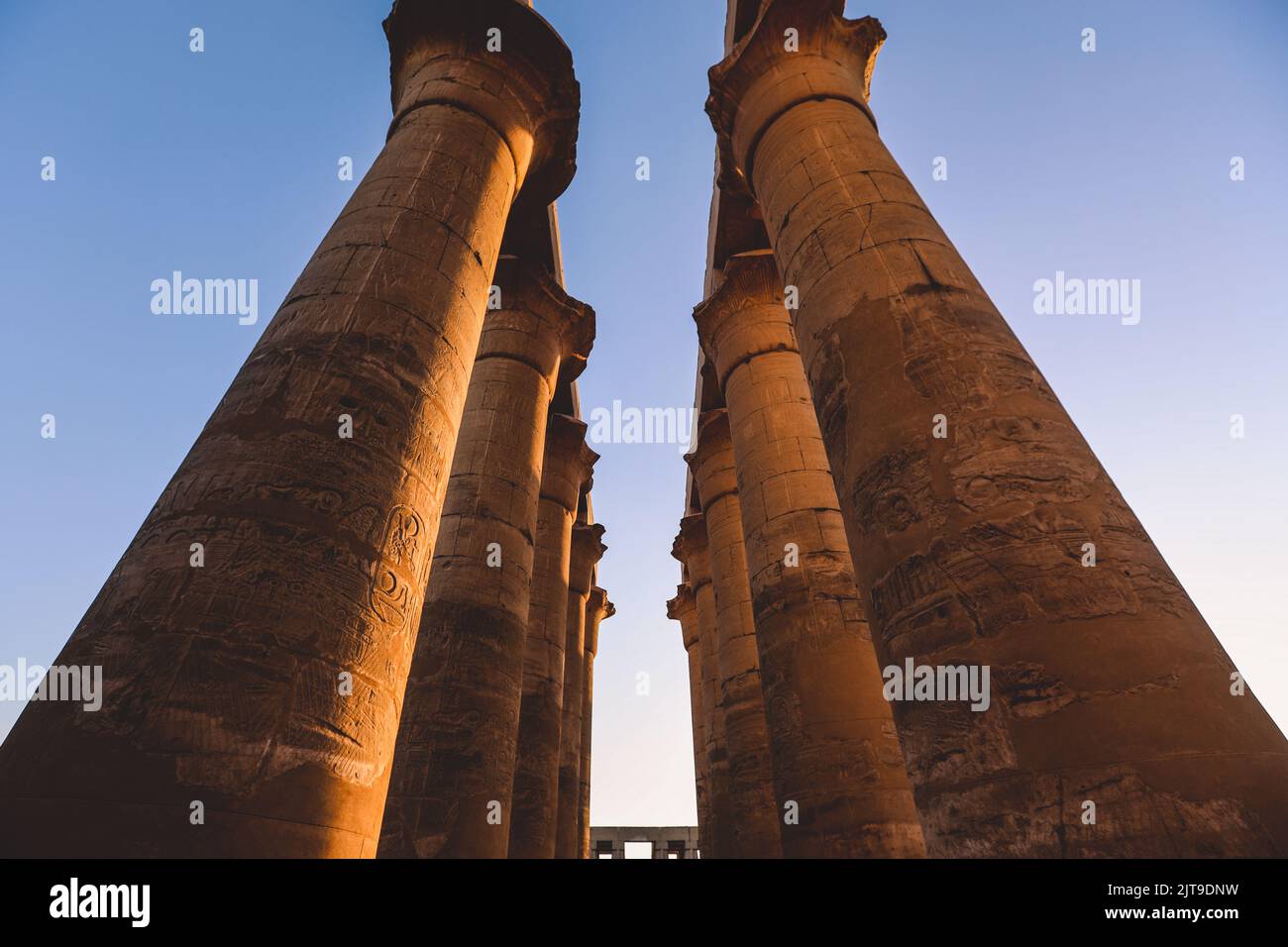 Sunset View to an Illuminated in Yellow Grand colonnade of large ...