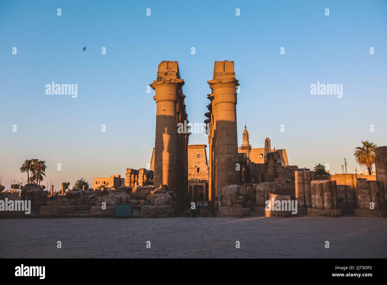Sunset View to an Illuminated in Yellow Grand colonnade of large ...