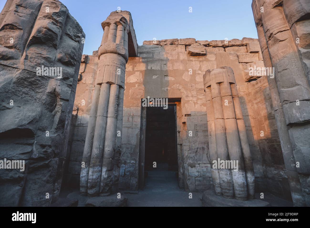 Sunset View to an Illuminated in Yellow Grand colonnade of large ...