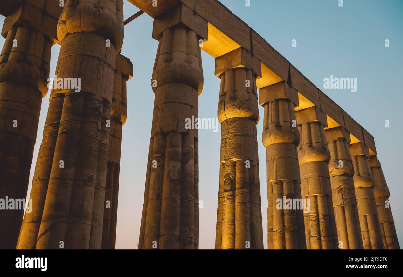 Sunset View to an Illuminated in Yellow Grand colonnade of large ...