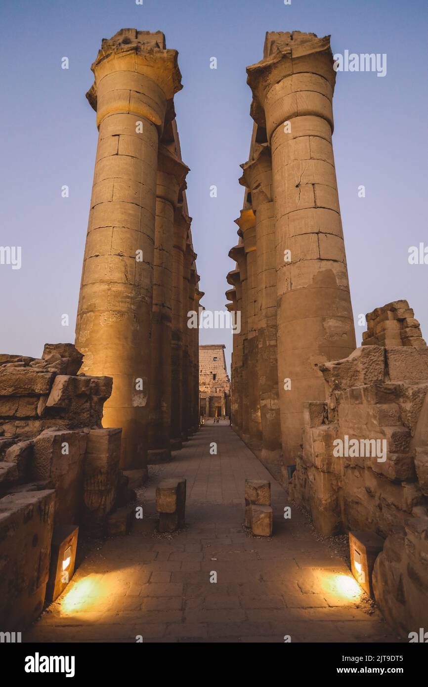 Sunset View to an Illuminated in Yellow Grand colonnade of large ...