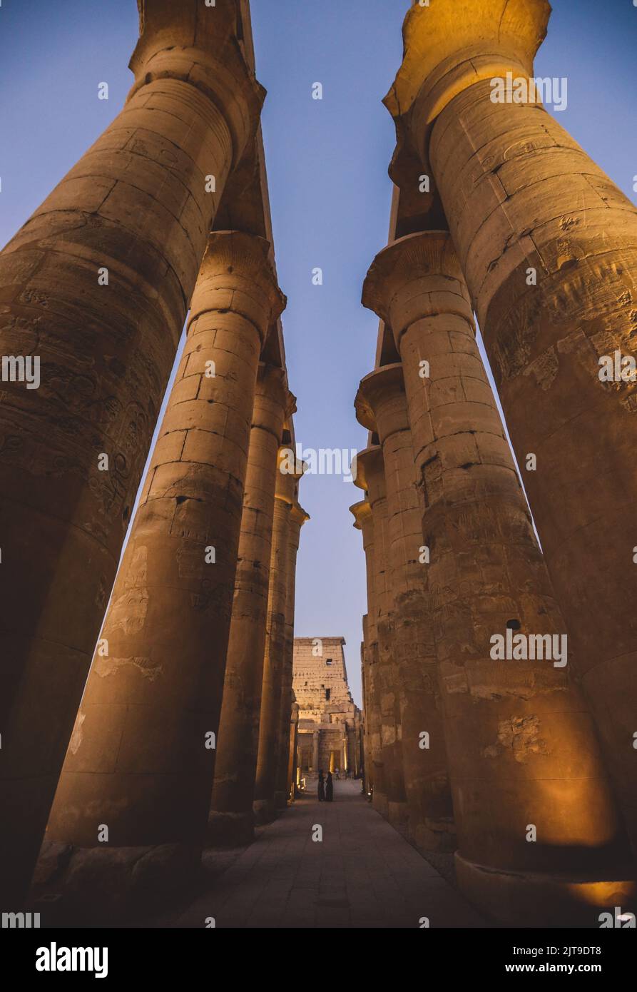 Sunset View to an Illuminated in Yellow Grand colonnade of large ...