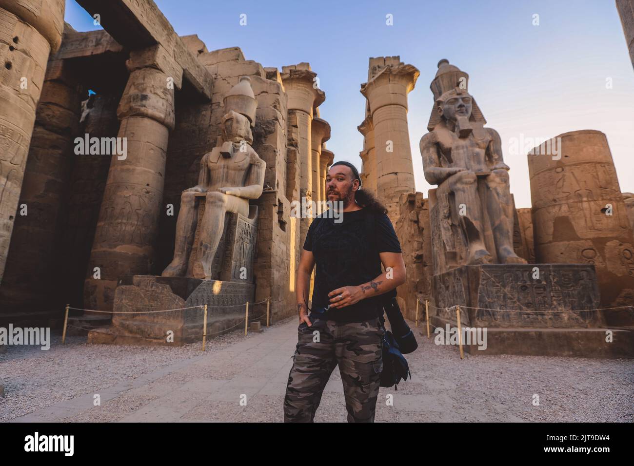 White Man Tourist looking at the Ancient Massive Columns of Luxor ...