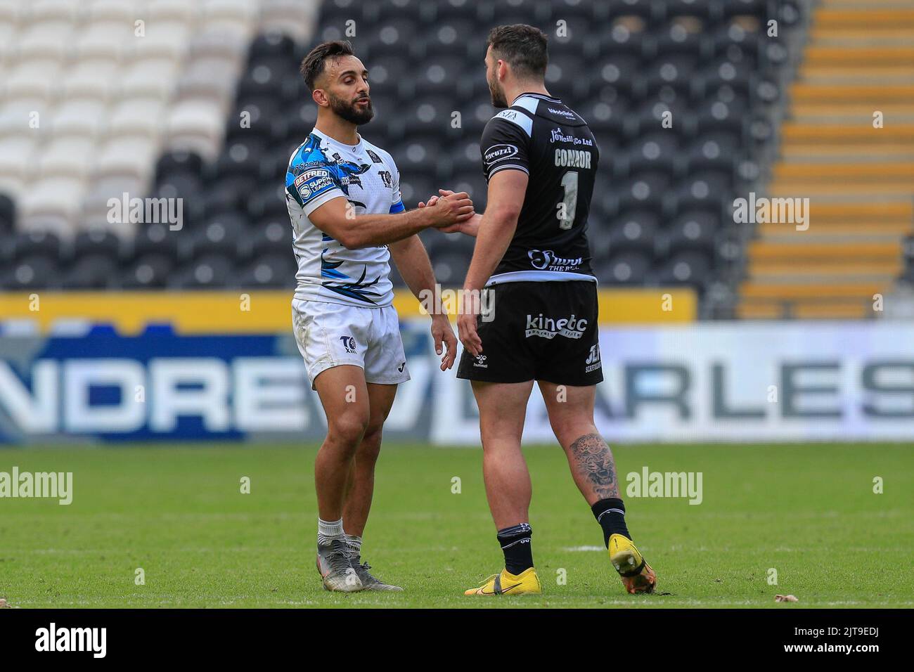 Jake Connor #1 of Hull FC shakes hands with Eloi Pelissier #14 of ...