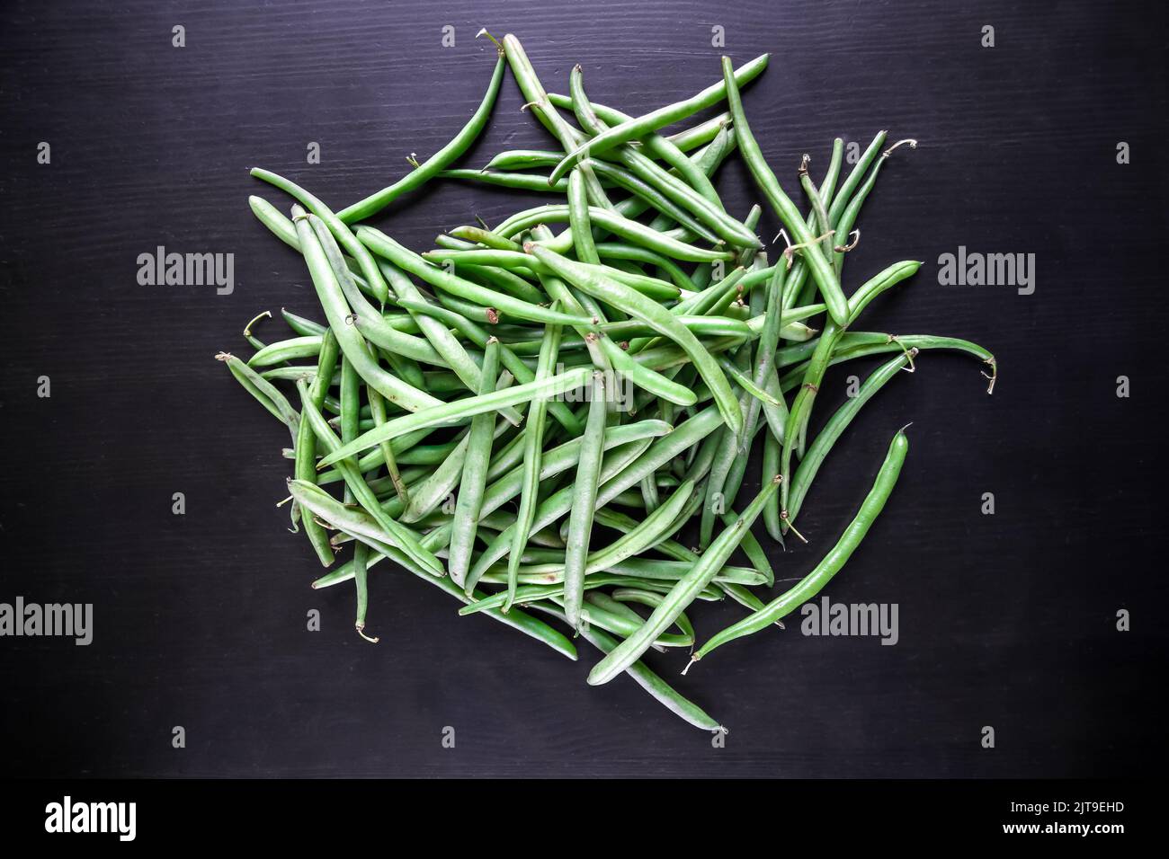 Fresh green beans isolated on black background Stock Photo - Alamy