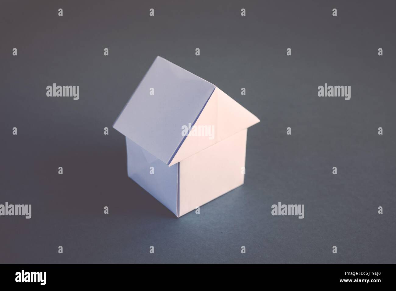 White paper house origami isolated on a blank grey background Stock ...