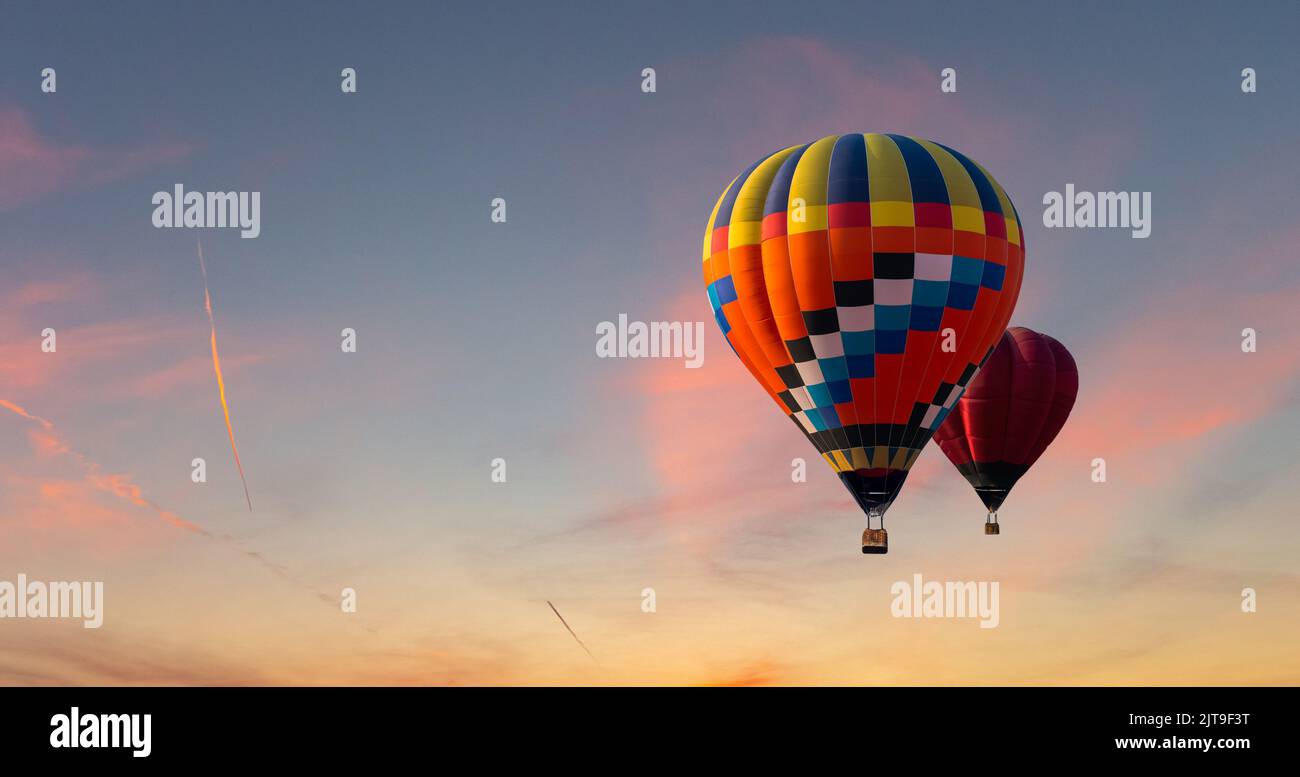 Colorful hot air balloons flying on the sunset sky background Stock Photo - Alamy
