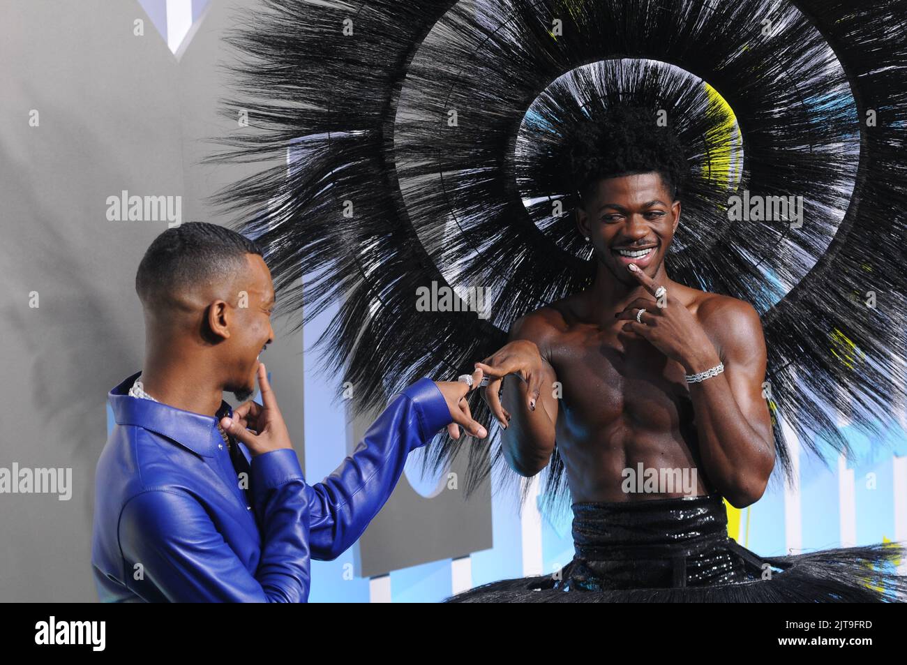 Harris Reed and Lil Nas X walking on the black carpet at the 2022 MTV ...