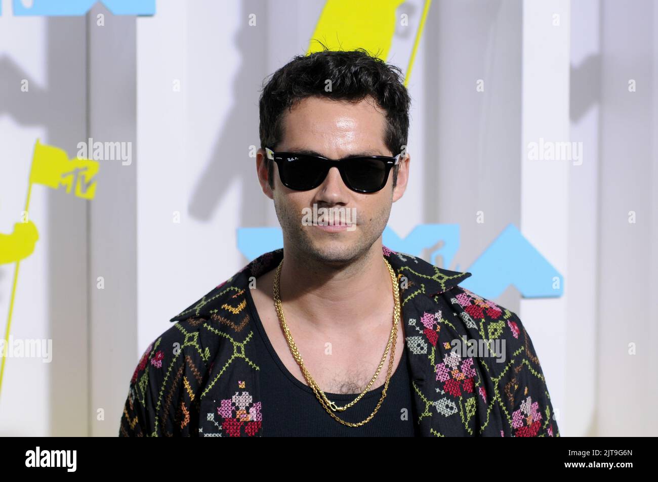 Dylan O'Brien walking on the black carpet at the 2022 MTV Video Music ...