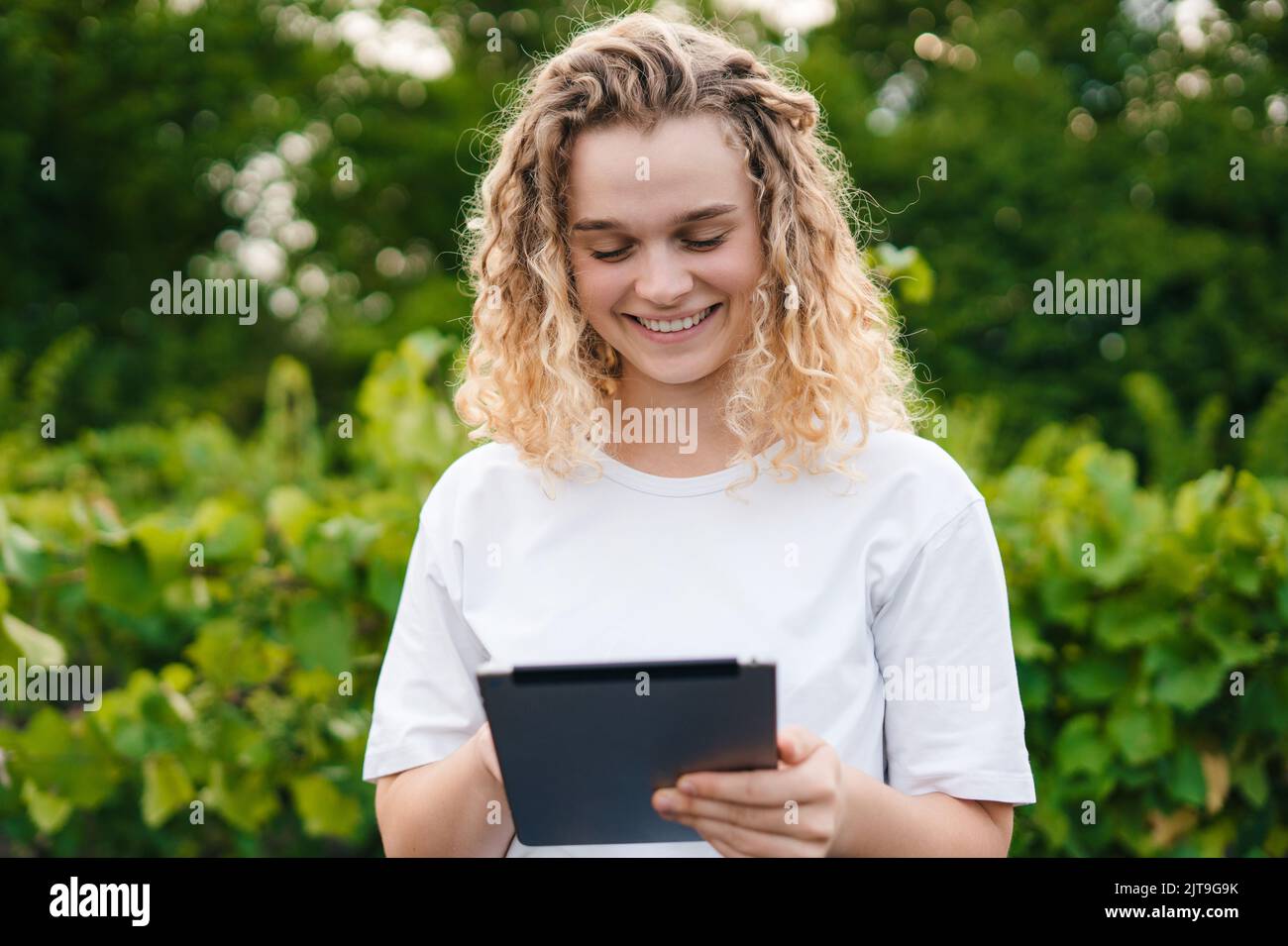 Front view portrait of a curly caucasian woman getting information on ...