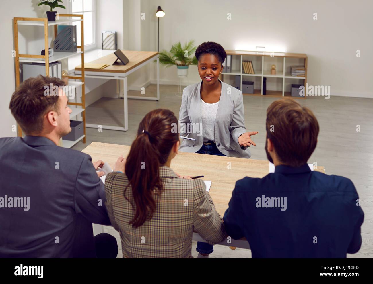 Female job applicant answers questions from employers during interview ...