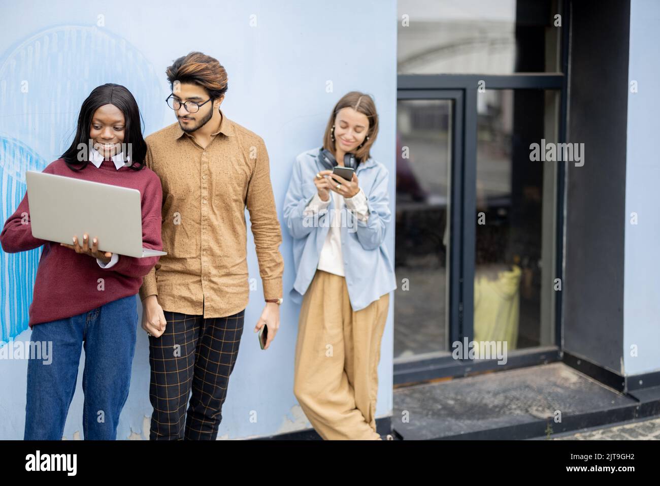 Young student use gadgets at university building Stock Photo - Alamy