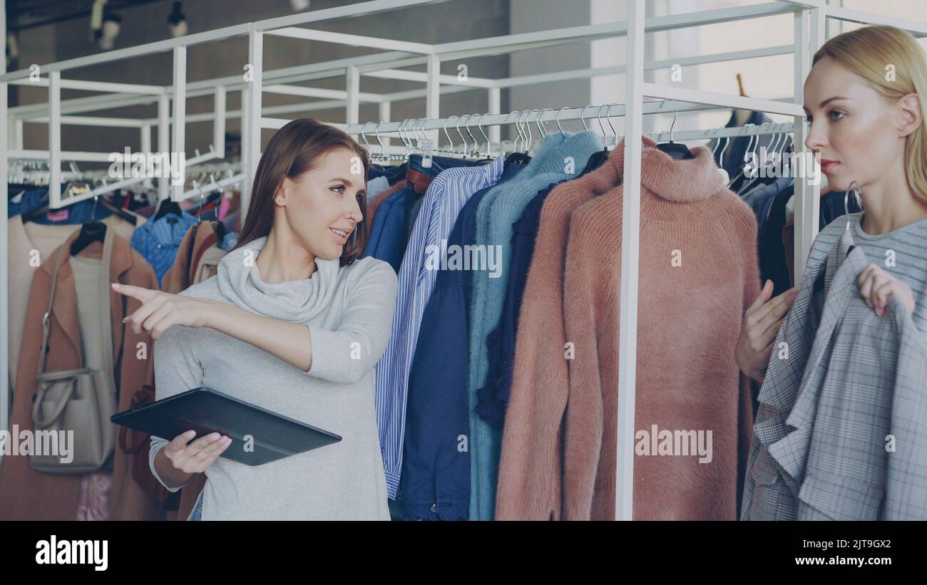 Young businesswoman is checking clothes in her clothing store with ...