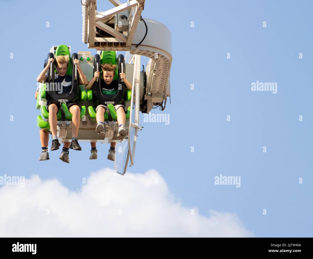 A "Booster" amusement ride (type pendulum) with two kids, coming down ...