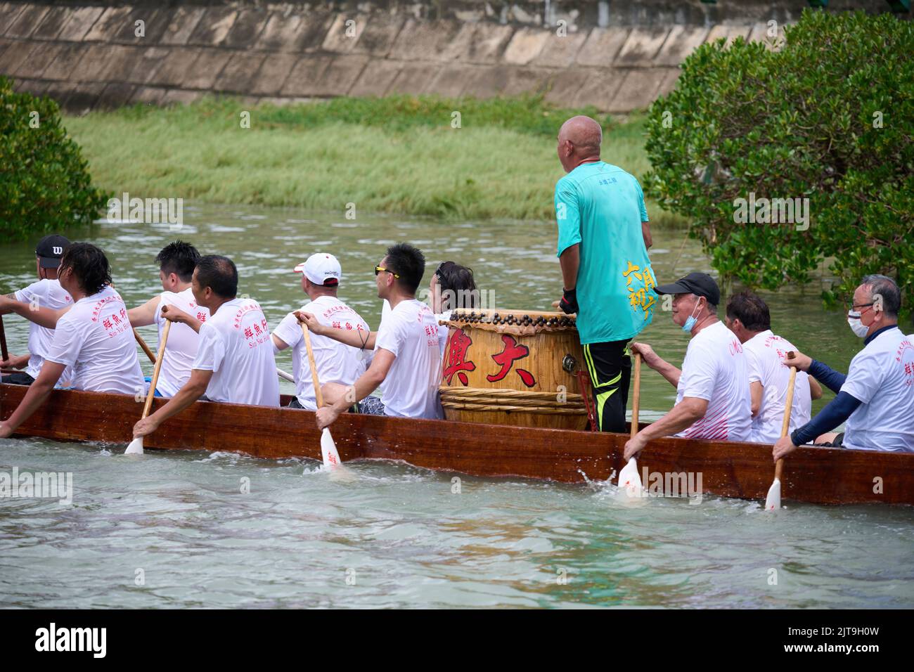 A closeup of People riding a dragon boat at Dragon Boat Festival in Tai ...