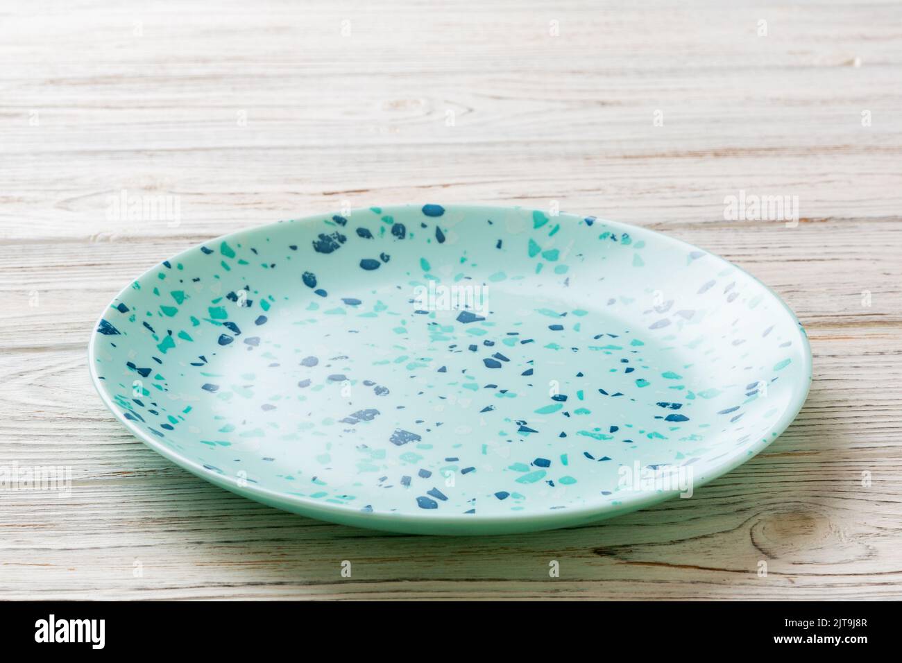 Perspective view of empty blue plate on wooden background. Empty space ...