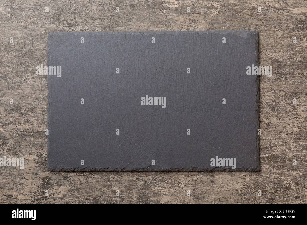 top view of empty black slate plate on cement background. Empty space ...