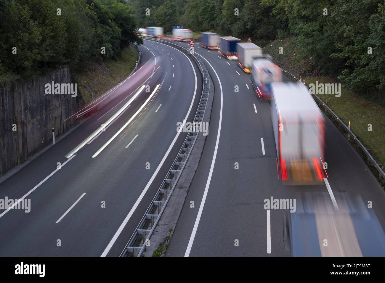 stack of trucks in a long traffic jam on the freeway at night Stock ...