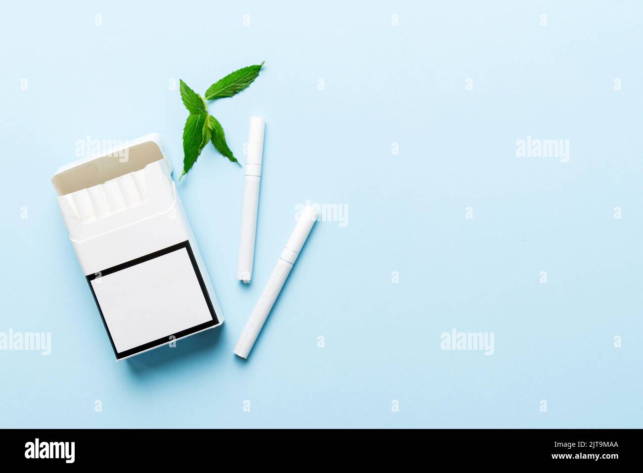 Pack of menthol cigarettes and fresh mint on colored table, Menthol ...