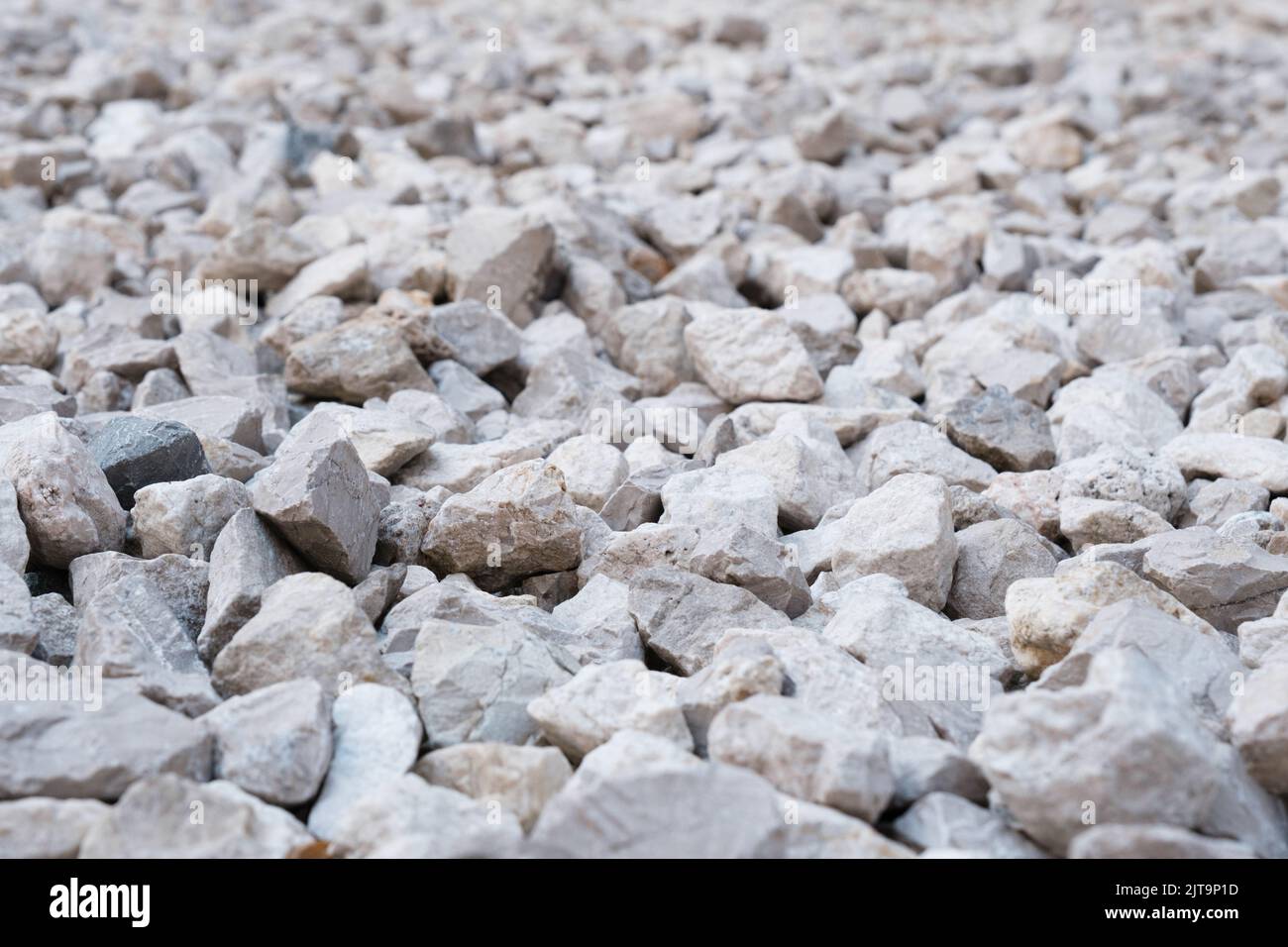 A pile of small white marble stones, close up of rocks, natural texture ...