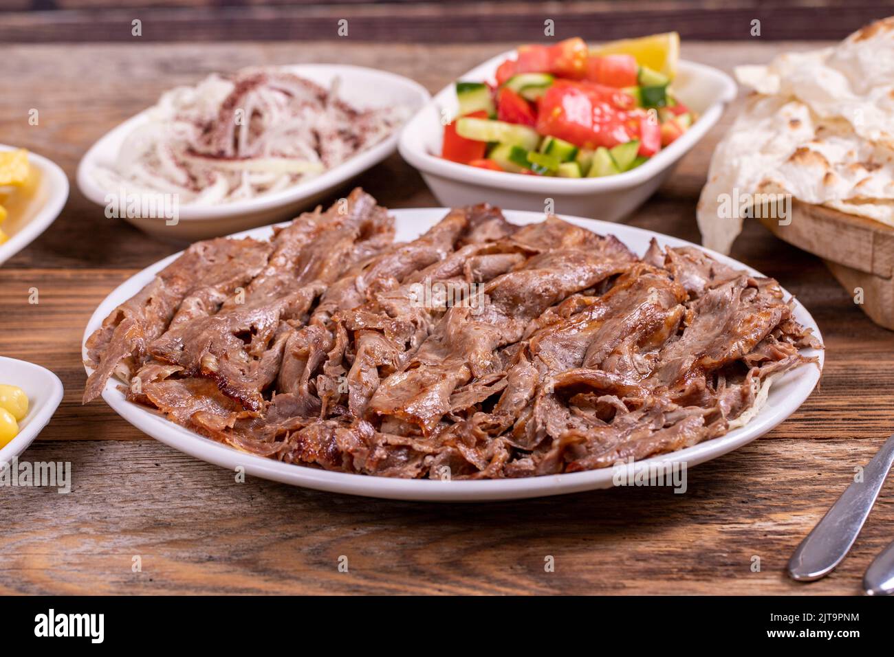 Meat doner kebab on the plate. Turkish meat doner kebab on wooden ...